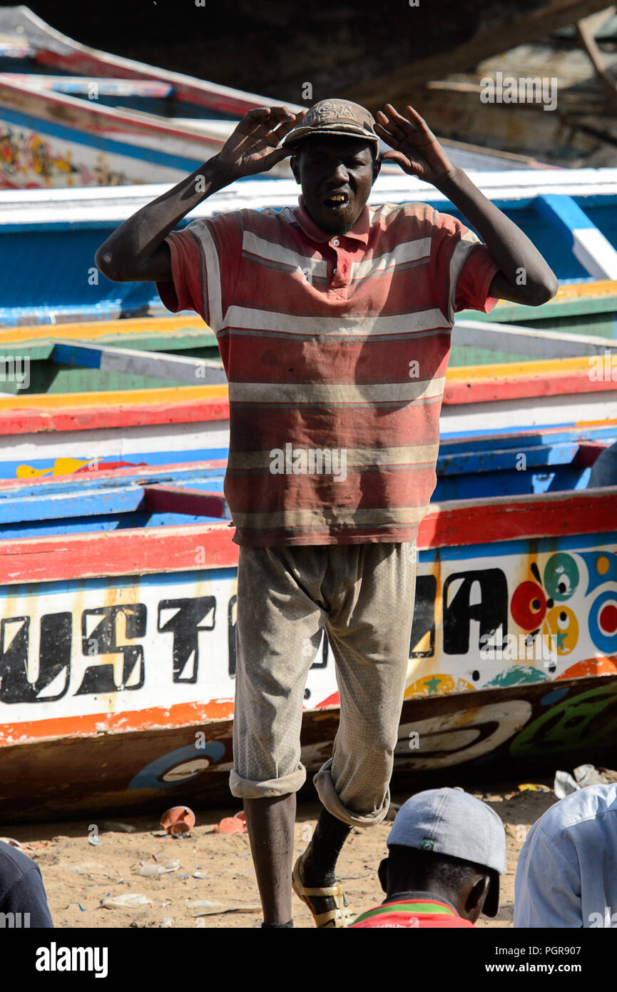 KAYAR, SENEGAL - APR 27, 2017: Unidentified Senegalese man raises his ...