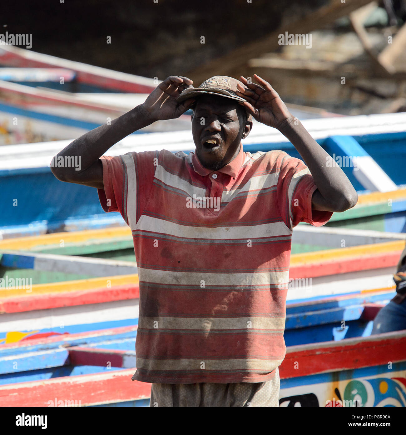 KAYAR, SENEGAL - APR 27, 2017: Unidentified Senegalese man raises his ...