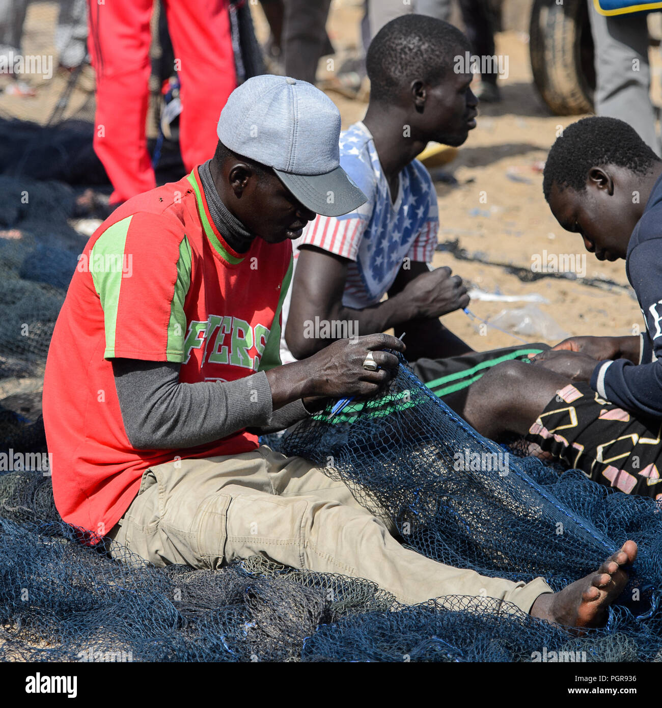 KAYAR, SENEGAL - APR 27, 2017: Unidentified Senegalese man sews a ...