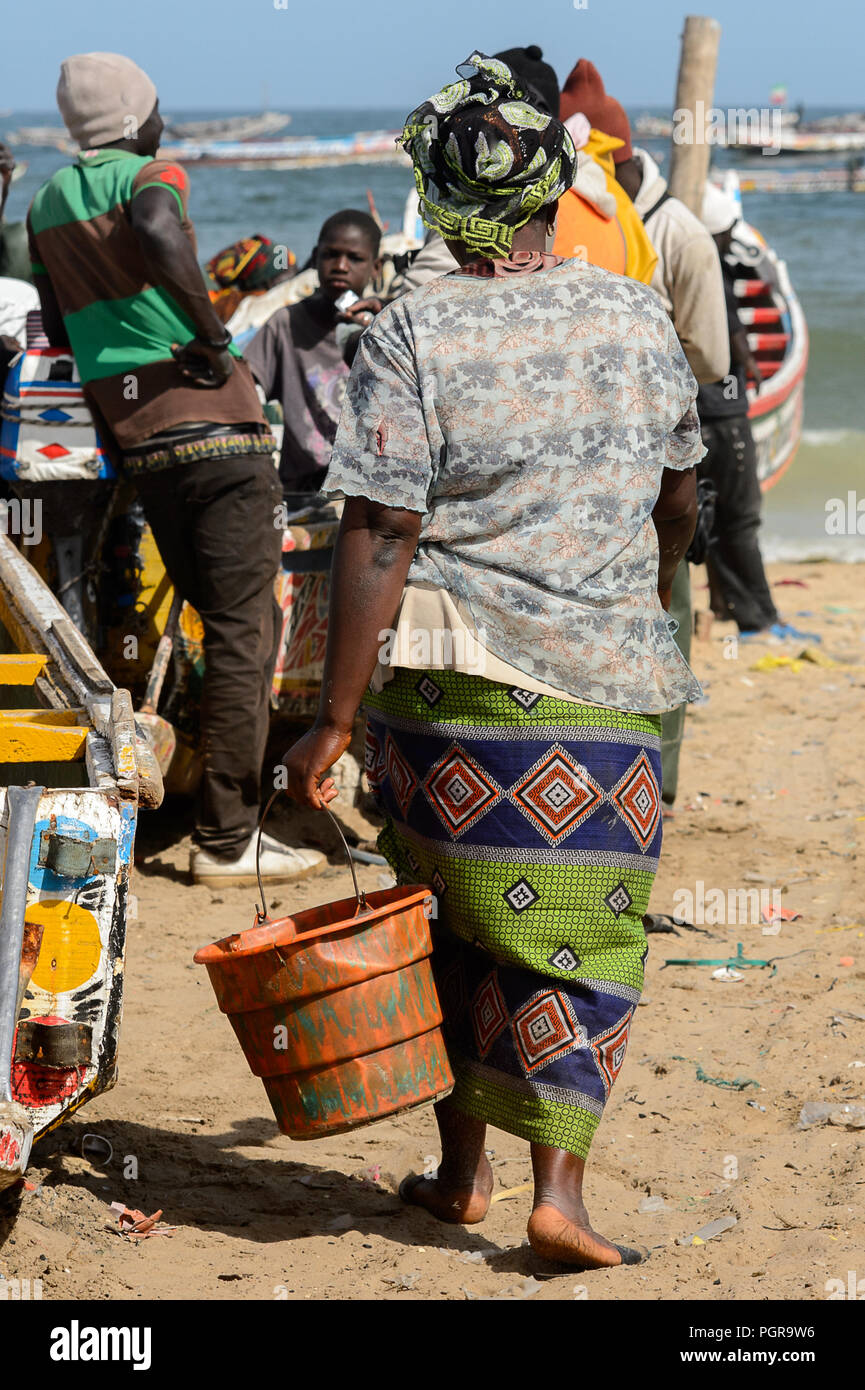 KAYAR, SENEGAL - APR 27, 2017: Unidentified Senegalese woman walks with ...