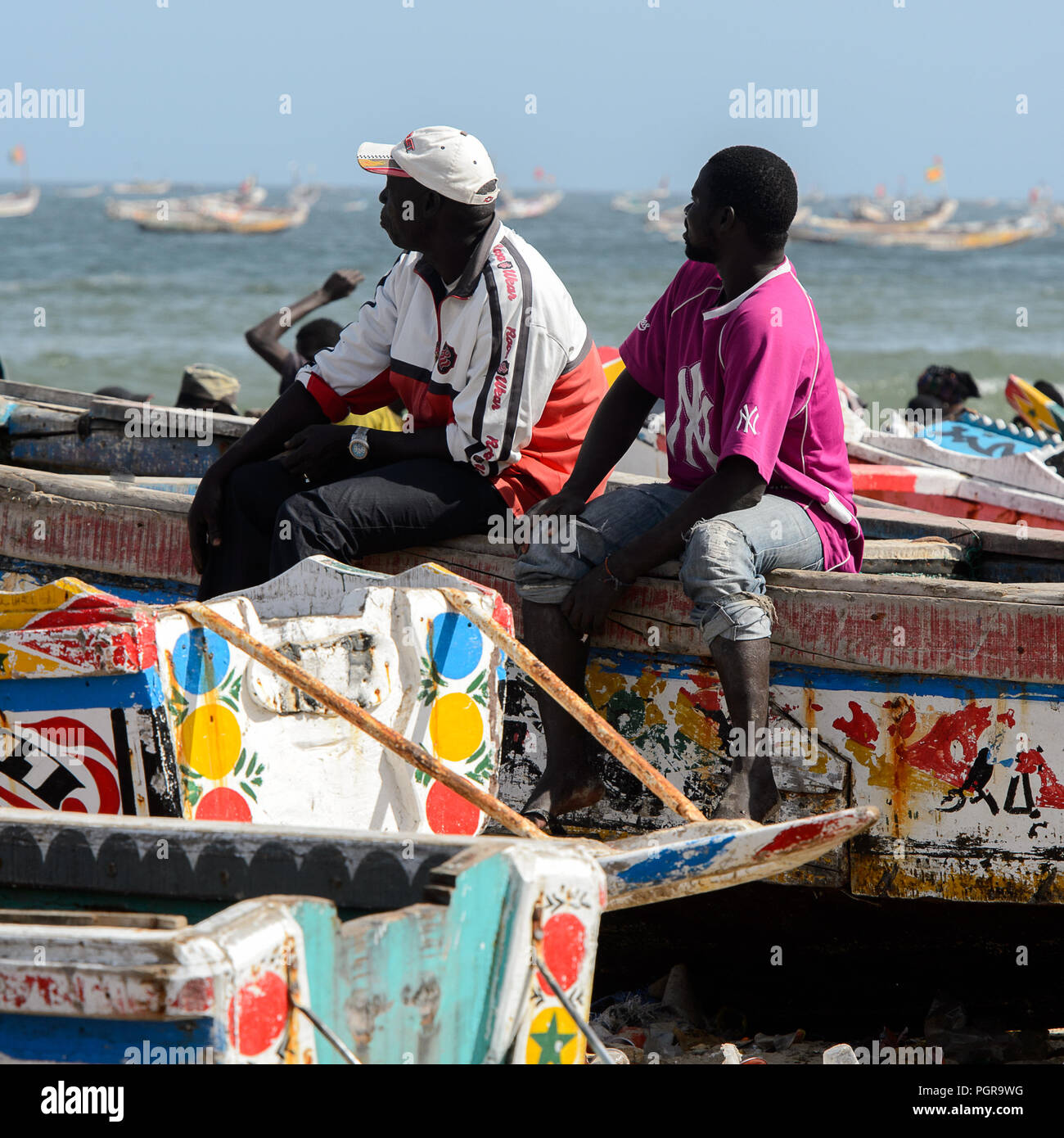 KAYAR, SENEGAL - APR 27, 2017: Unidentified Senegalese men sit on the ...