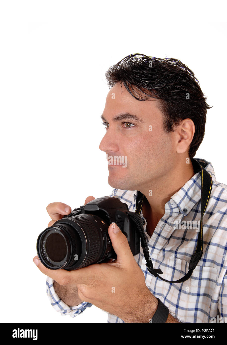A close-up image of a handsome man holding his camera ready of a shoot ...