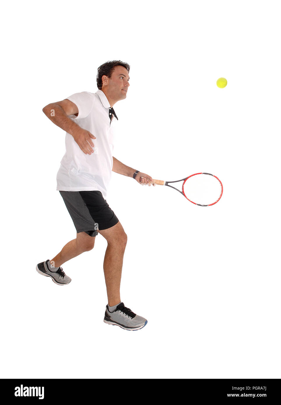 A full body image of a tennis player practicing his game in the studio ...
