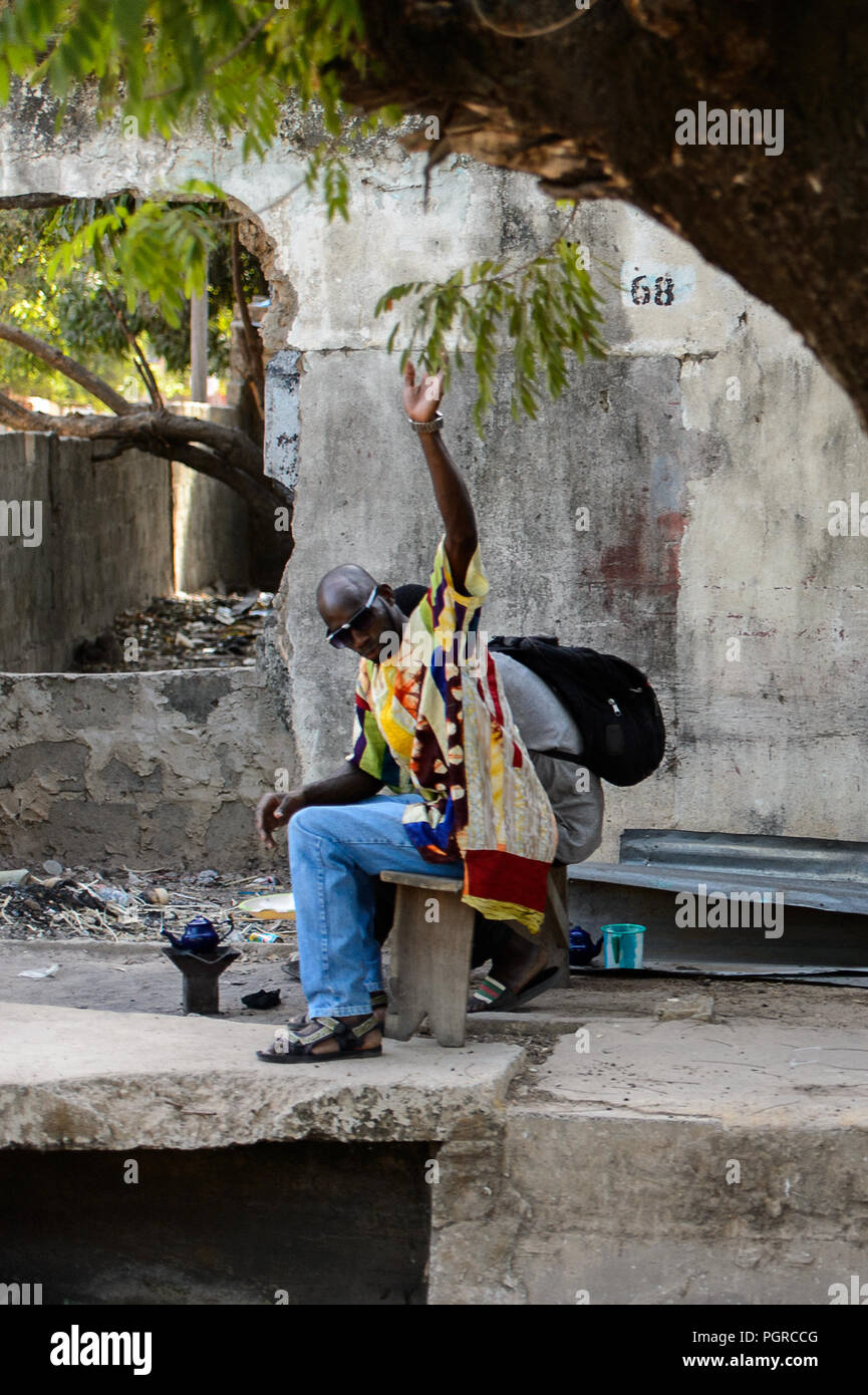 ZIGUINCHOR, SENEGAL - APR 28, 2017: Unidentified Senegalese people sit ...