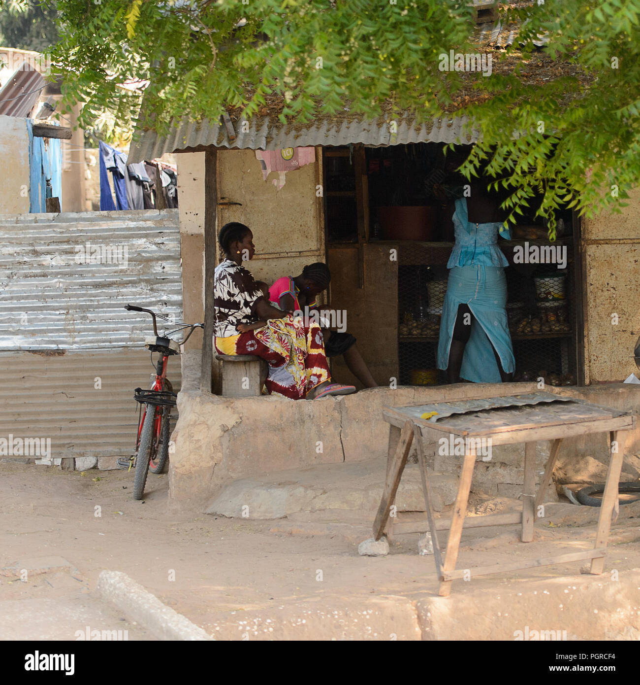 ZIGUINCHOR, SENEGAL - APR 28, 2017: Unidentified Senegalese women sit ...