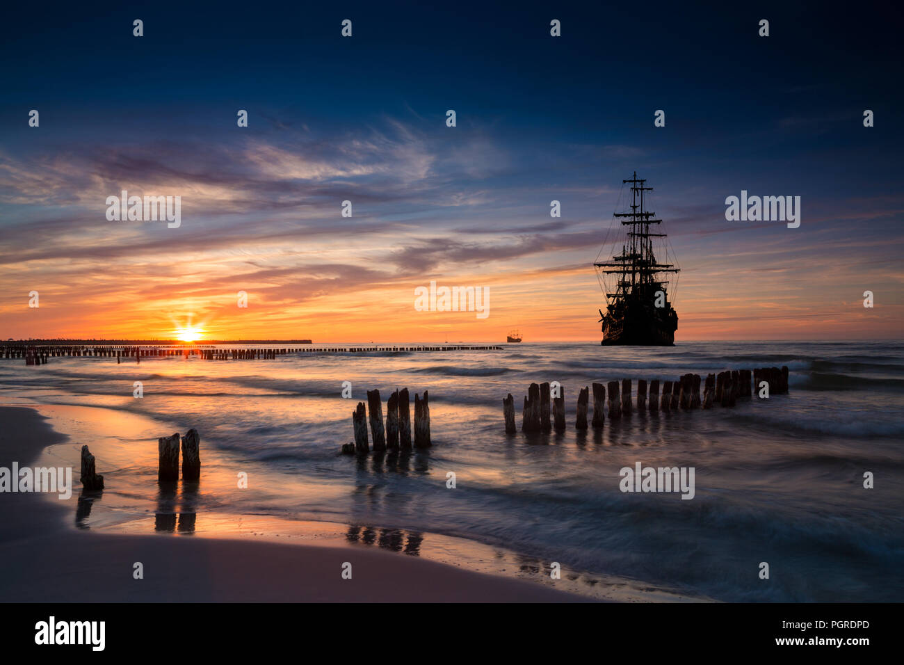 Old ship silhouette in sunset scenery Stock Photo - Alamy