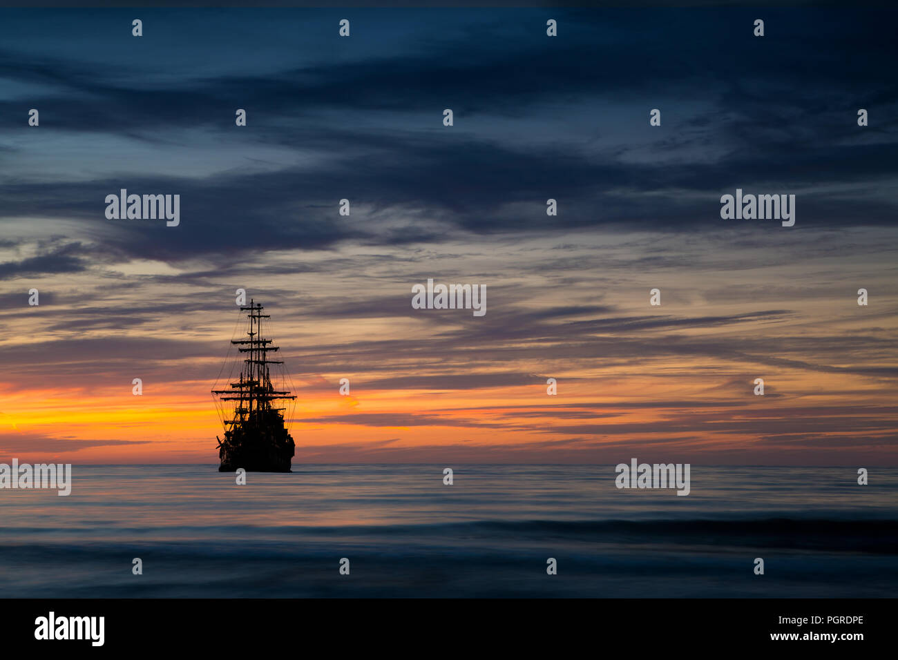 Old ship silhouette in sunset scenery Stock Photo - Alamy