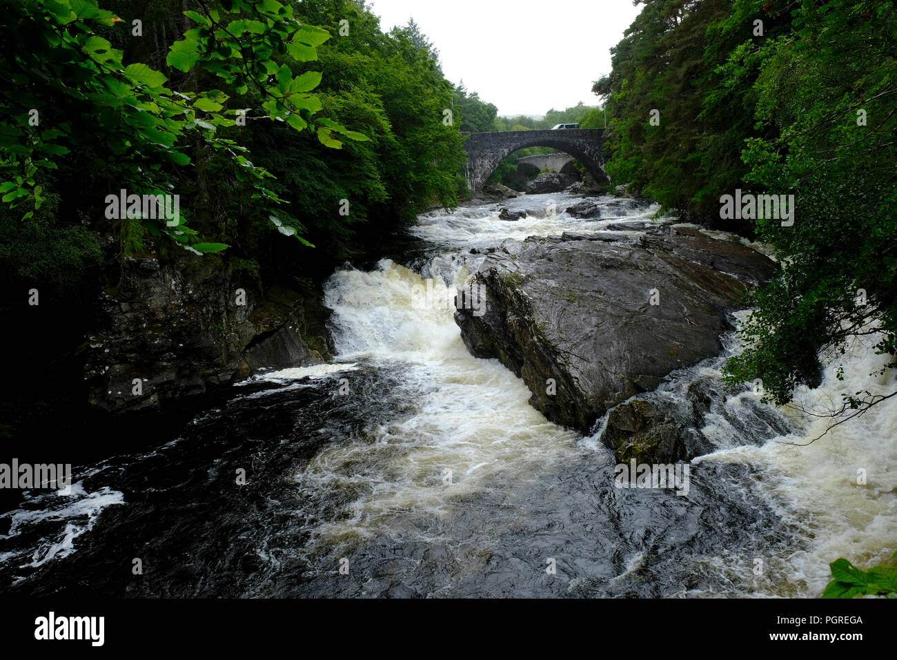Invermoriston Falls, Scotland nicely flowing with bridge in background ...