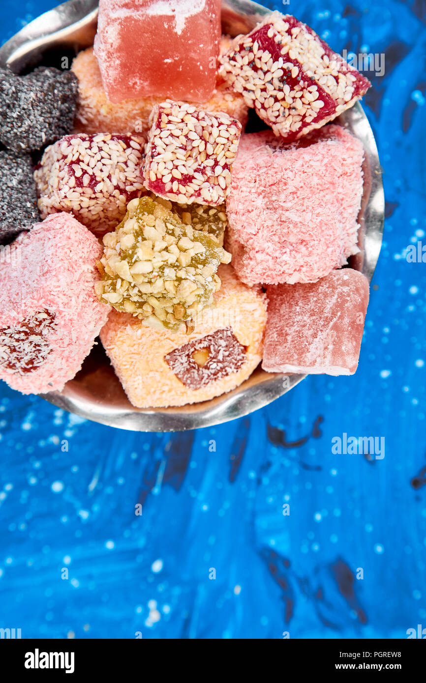 Set of various Turkish delight in traditional silver bowl l on blue ...