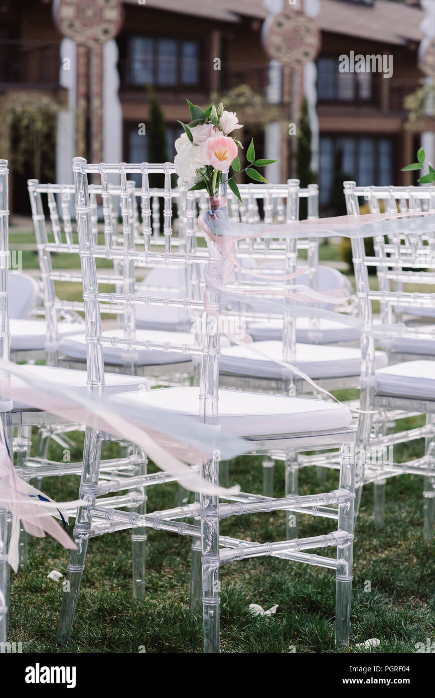White chairs for guests at a luxury wedding ceremony Stock Photo - Alamy