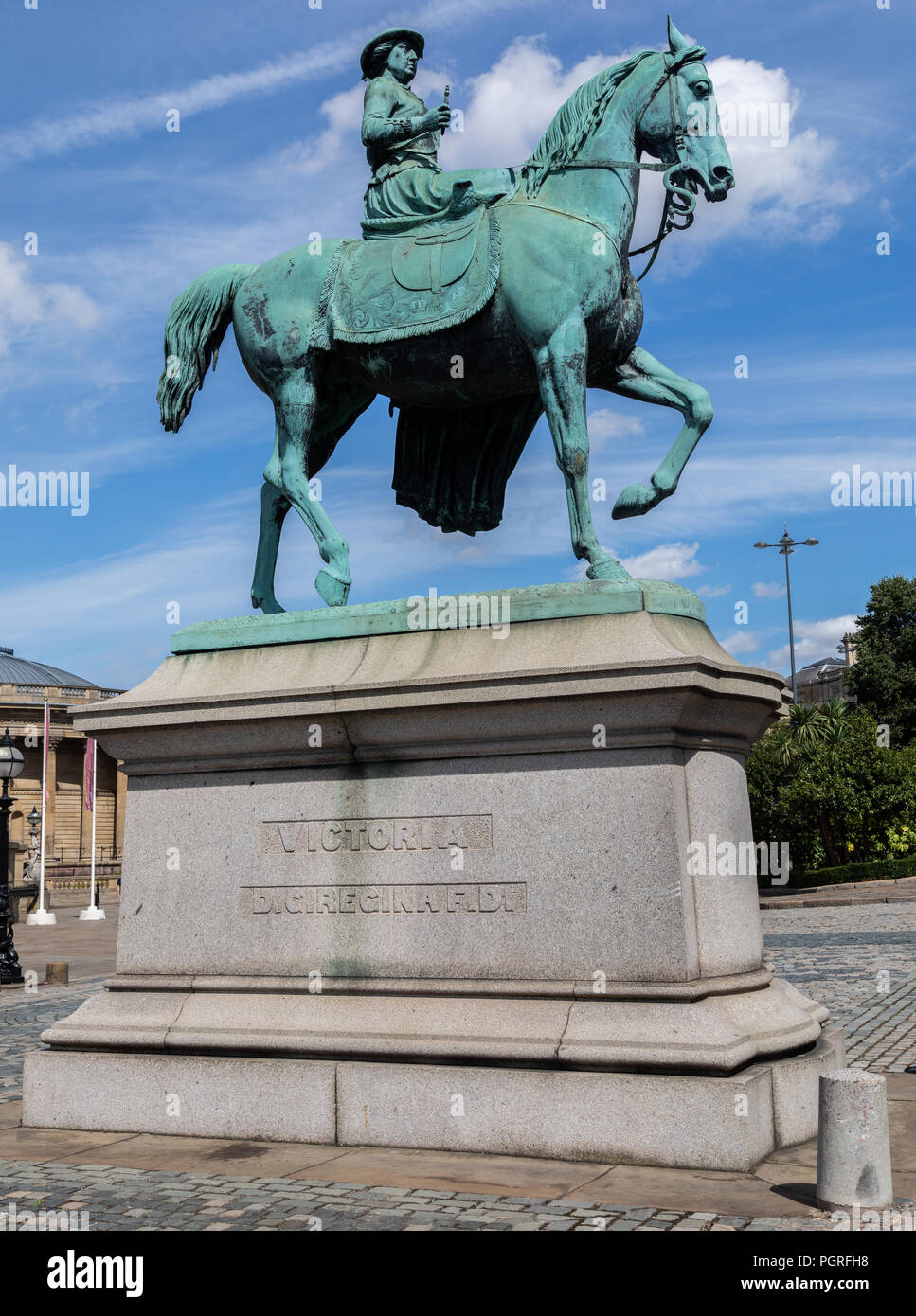 A statue of Queen Victoria riding a horse on a plinth on St George's ...
