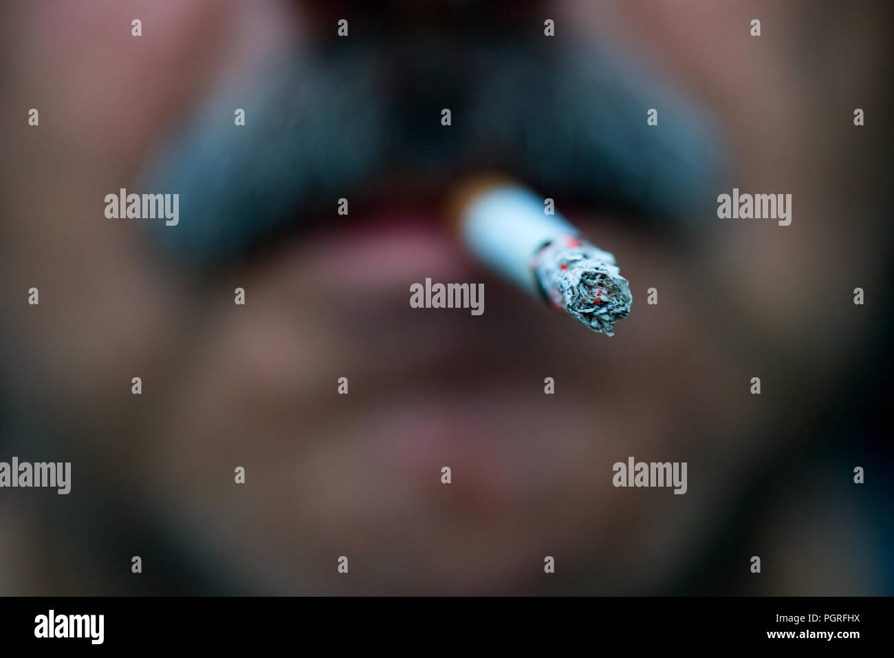Man smoking a cigarette. Cigarette smoke spread. Healthy lifestyle ...