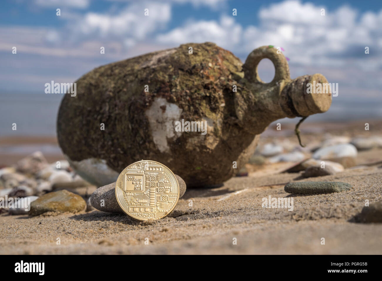 bitcoin on the beach in the sand against the sea Stock Photo - Alamy