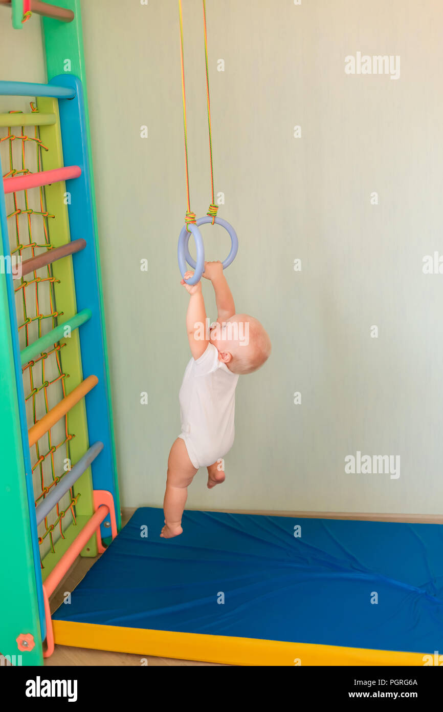Happy boy and girl hanging on bars hi-res stock photography and images ...