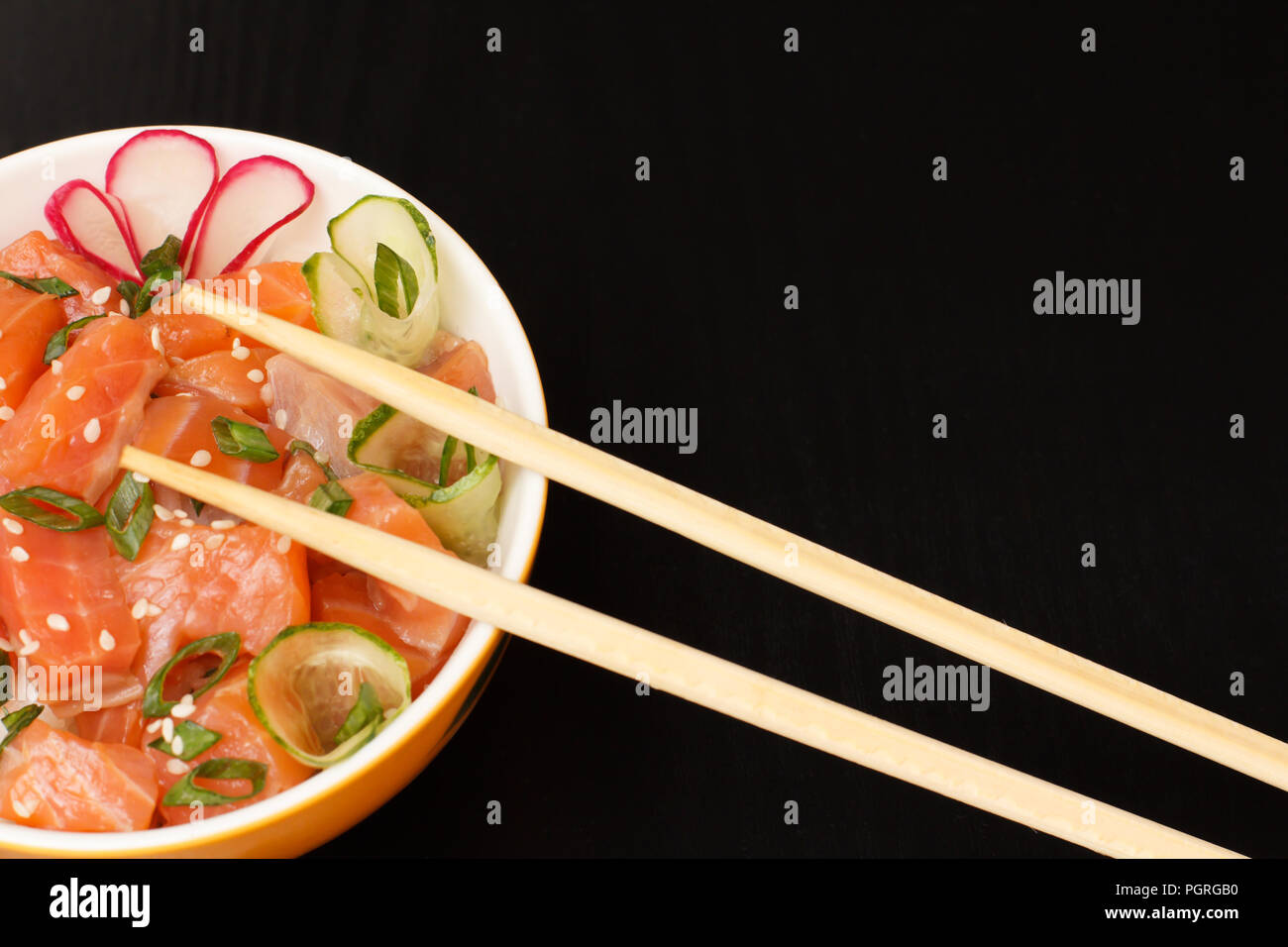 Hawaiian poke with salmon and sesame seeds, fresh cucumber, radish and ...