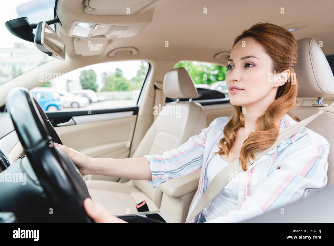 side view of pensive attractive woman driving car Stock Photo - Alamy