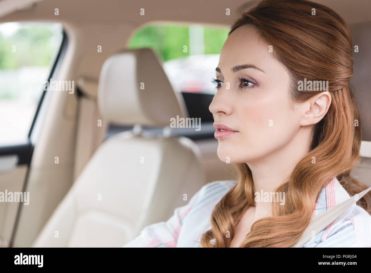 side view of focused woman driving car alone Stock Photo - Alamy