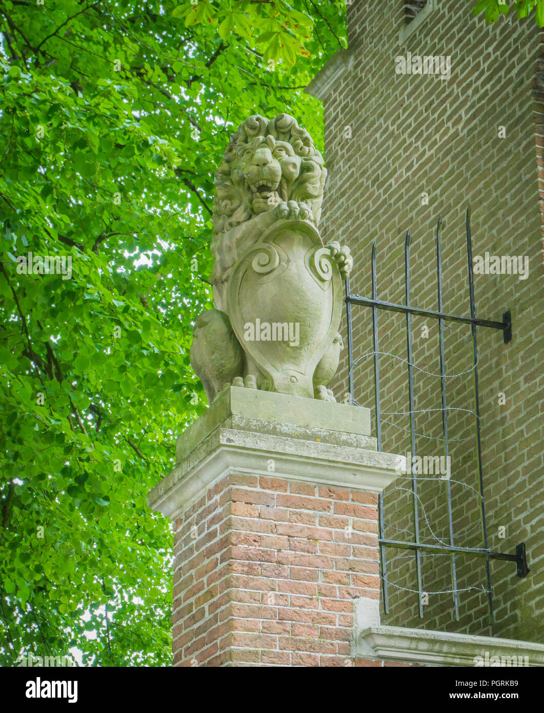stone lion statue on a brick pole Stock Photo - Alamy