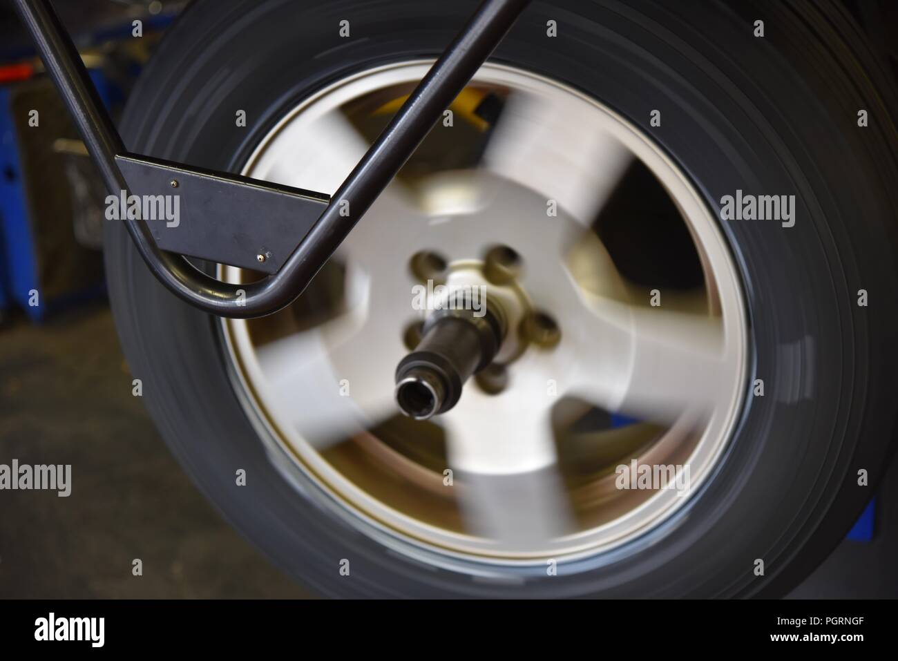Tyre/tire fitting: a wheel with a new tyre undergoes a wheel balancing ...
