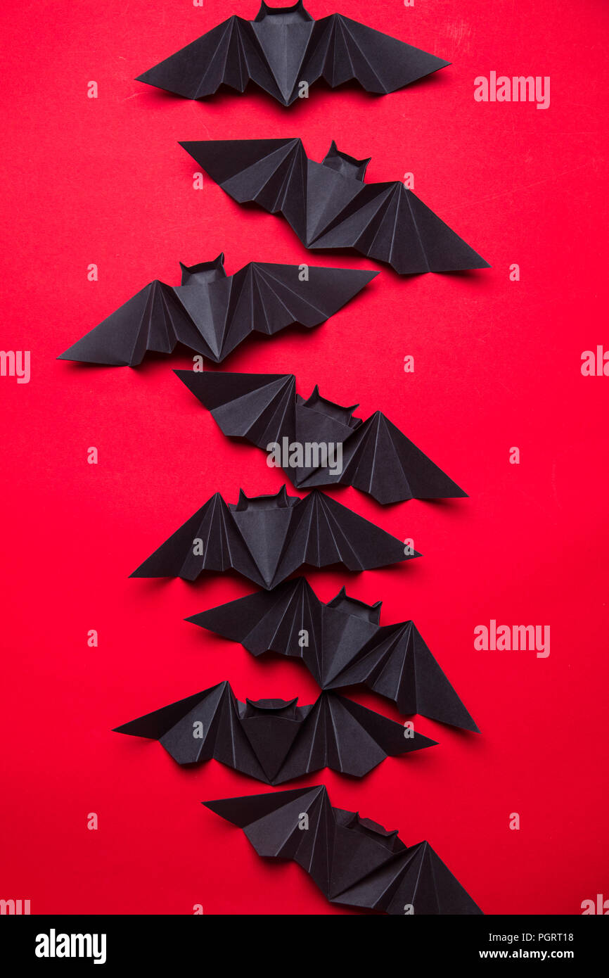 Halloween bats made from paper on a red background Stock Photo - Alamy