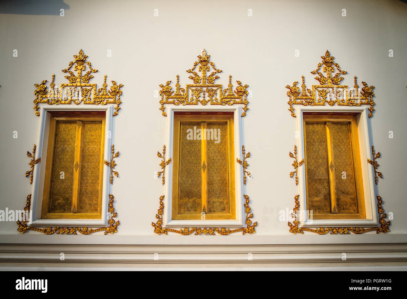 Beautiful golden window with white cement background in Thai temple ...