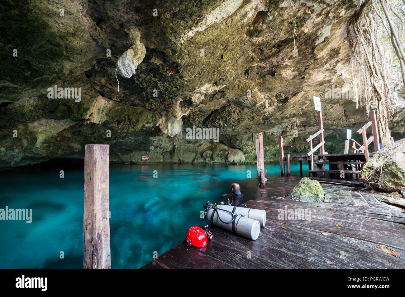 One of the cavern entrances to Dos Ojos cenote near Tulum, Mexico with ...