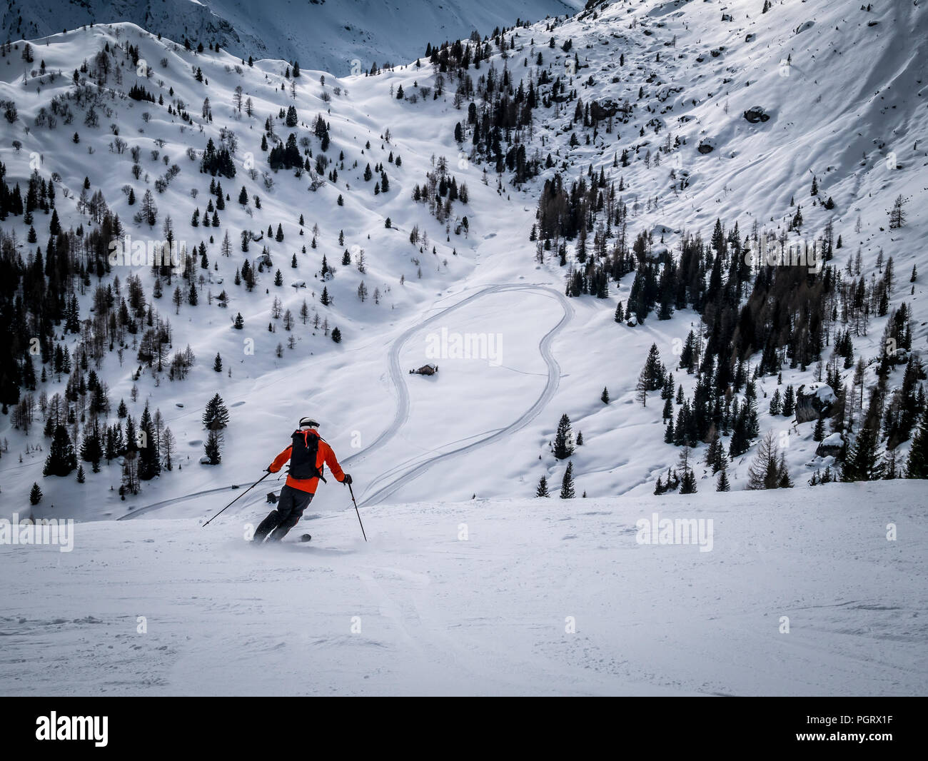 Freeride skier riding in snow in piste downhill in the Italien Alps ...