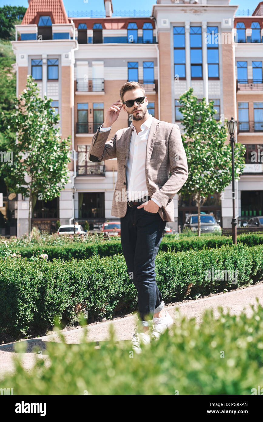 Handsome elegant young man in urban setting in European city, walking ...
