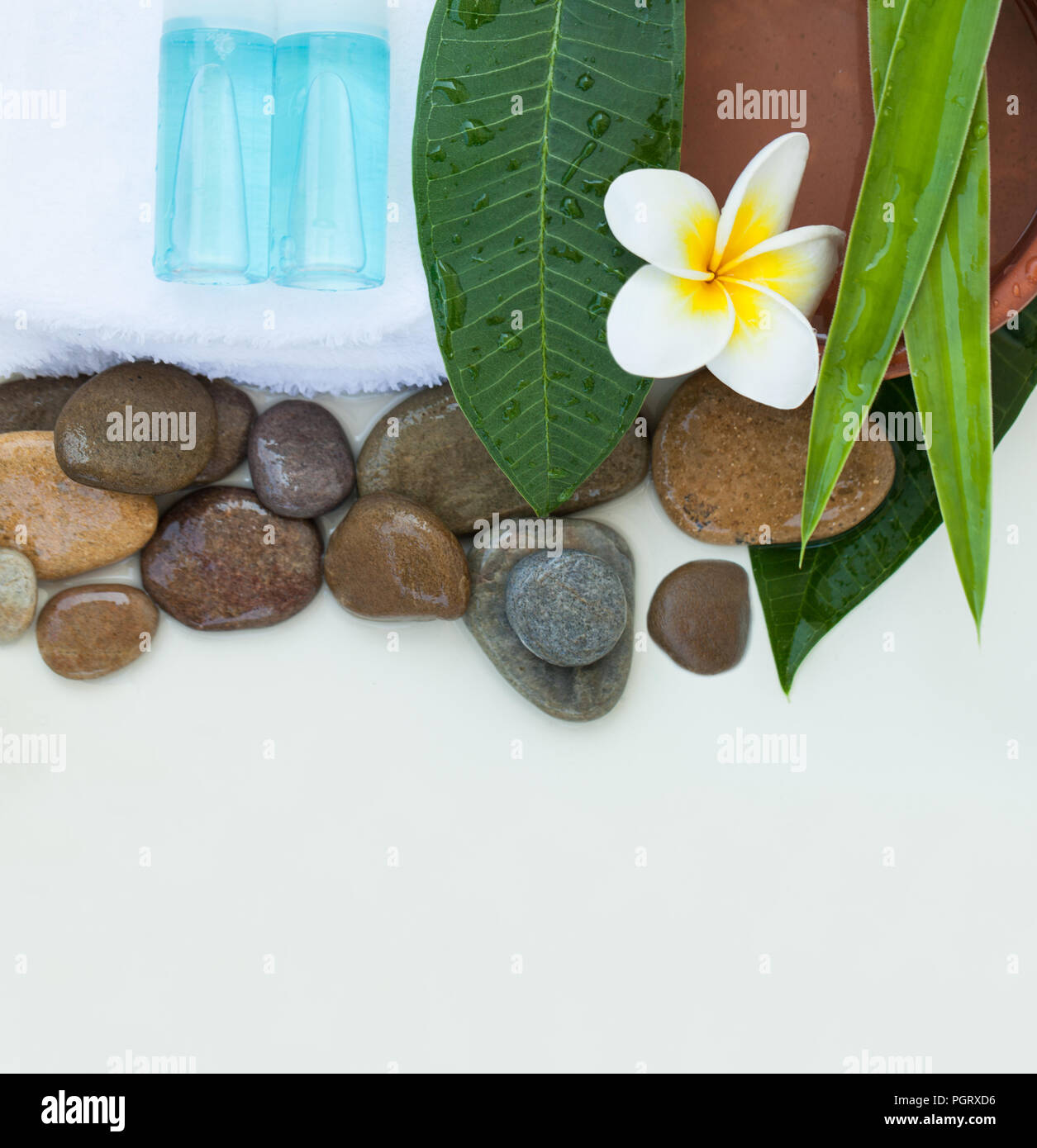 Spa or wellness background with white towels, tropical leaves, flowers ...