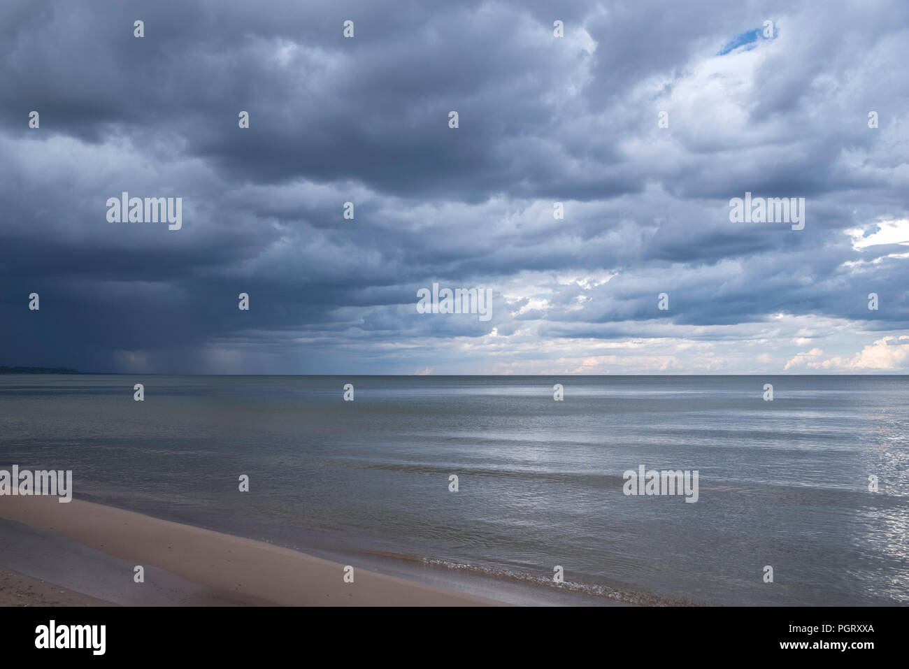 Sunset at the sea. It's raining Stock Photo - Alamy