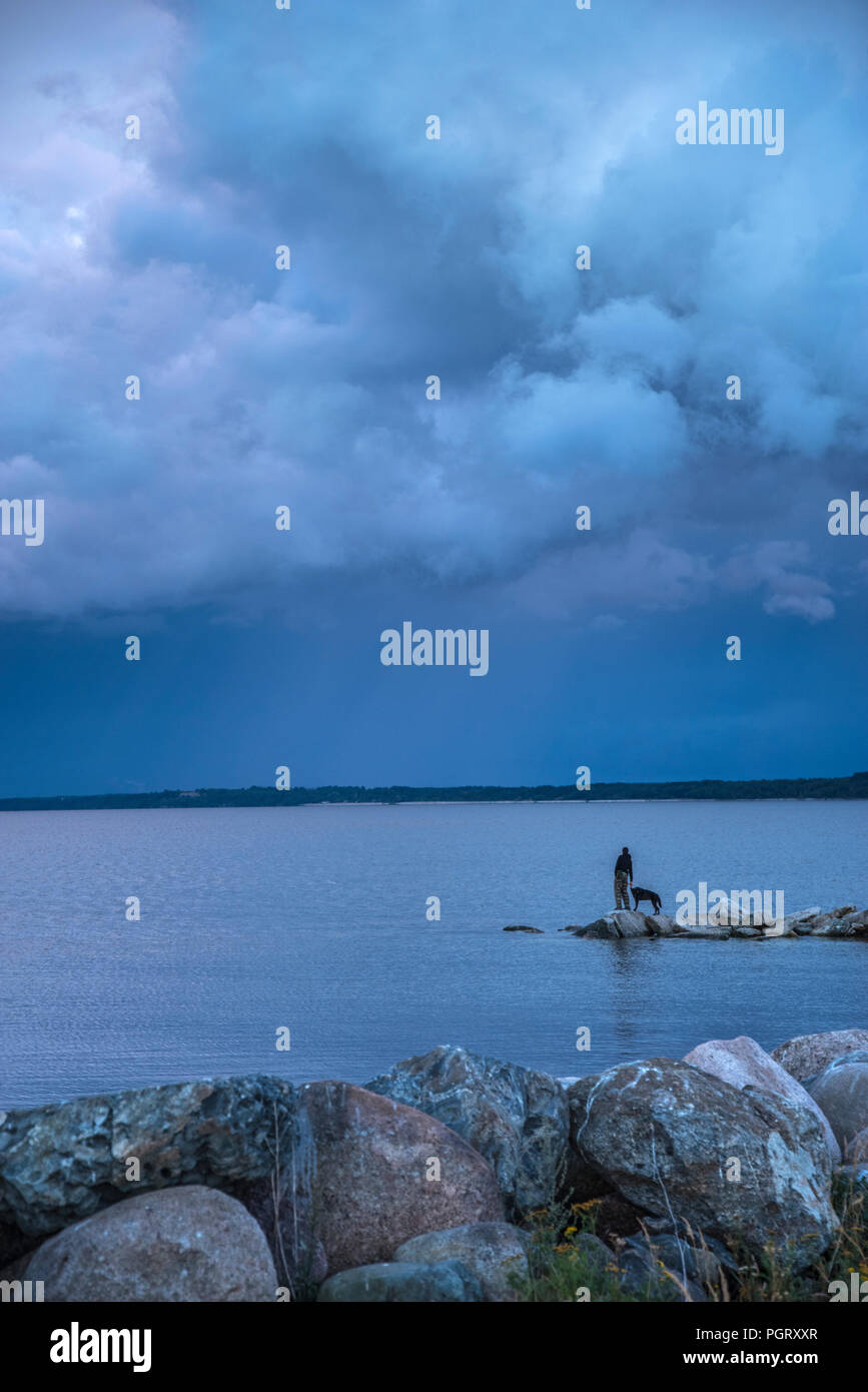 Sunset at the sea. It's raining Stock Photo - Alamy