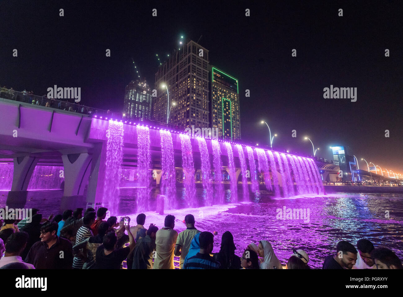 People on the promenade overlooking the mechanical waterfall, where the ...