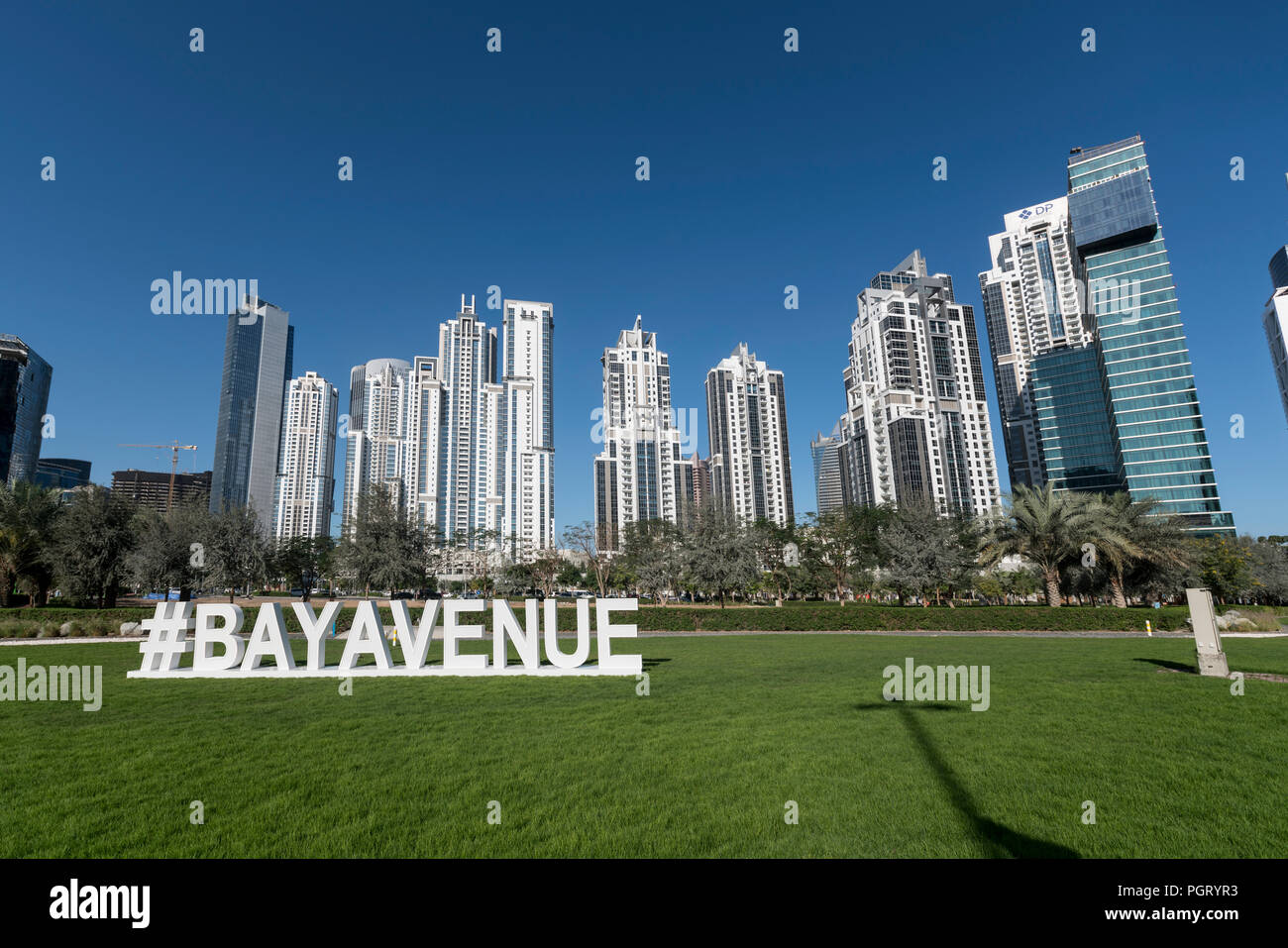 Signage for Bay Avenue Mall, with the skyscrapers of Business Bay in ...