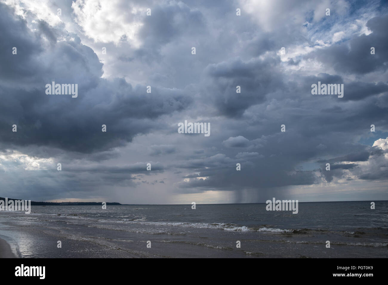 Sunset at the sea. It's raining Stock Photo - Alamy