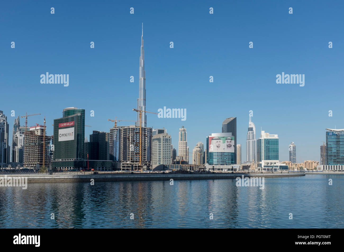Towers lining the Dubai Water Canal in Business Bay, Dubai, UAE, with ...