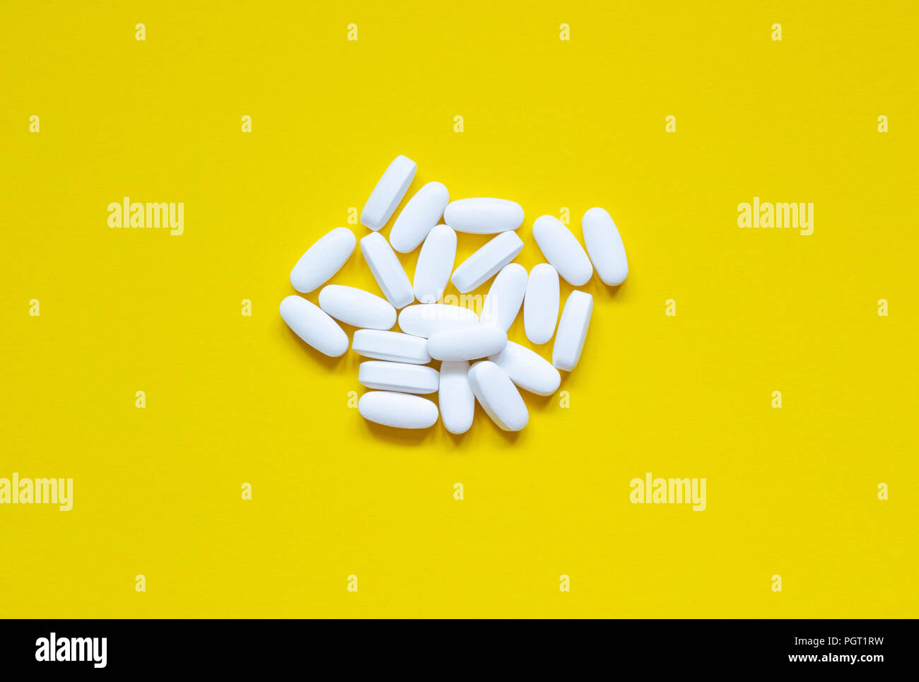 A lot of pills on a yellow background, concept of health Stock Photo ...