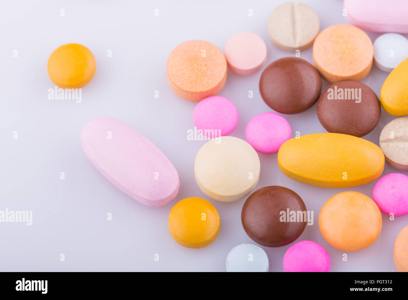 Tablets pills capsule heap mix therapy drugs, over a white background ...