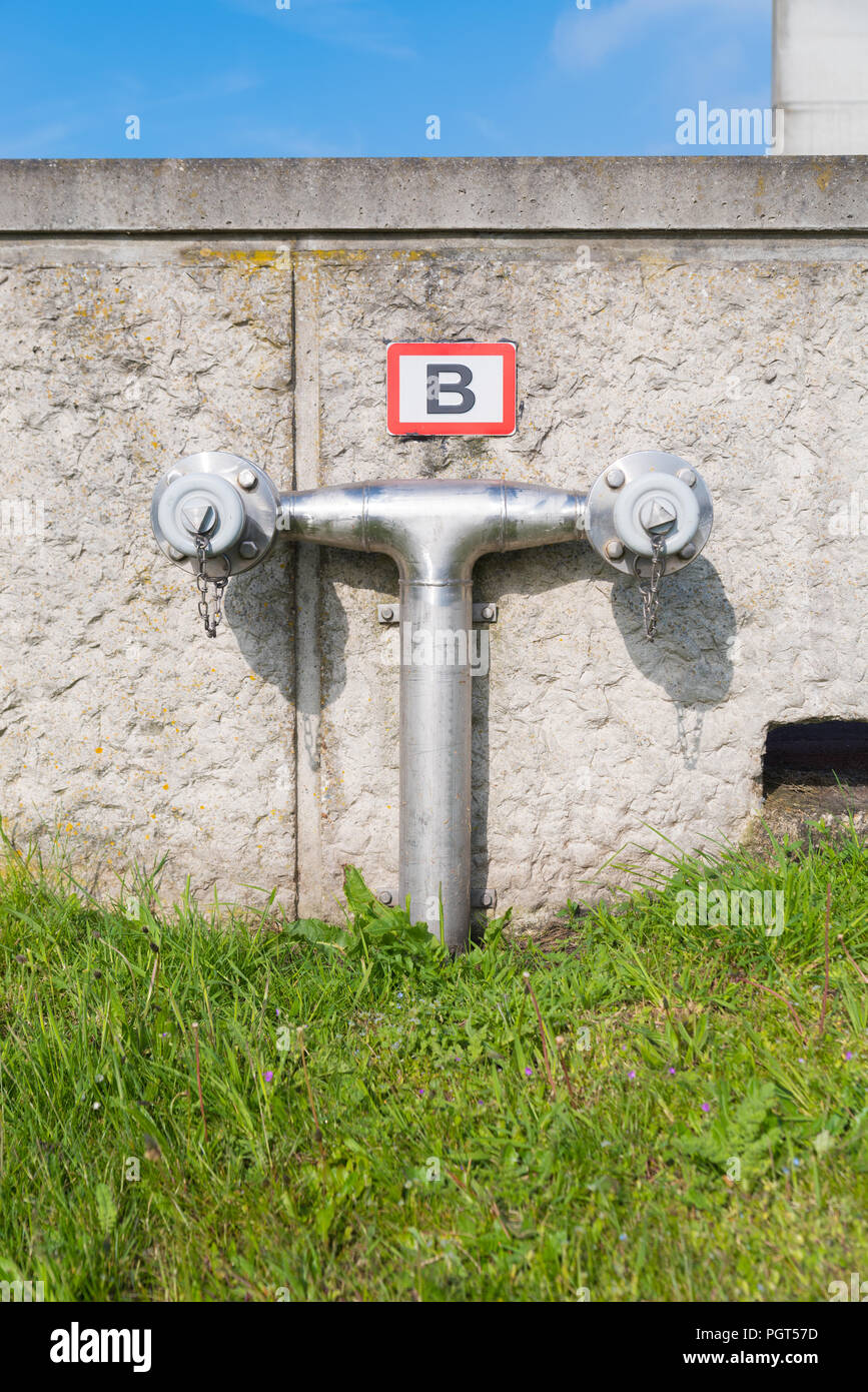 double fire hydrant at a wall Stock Photo - Alamy