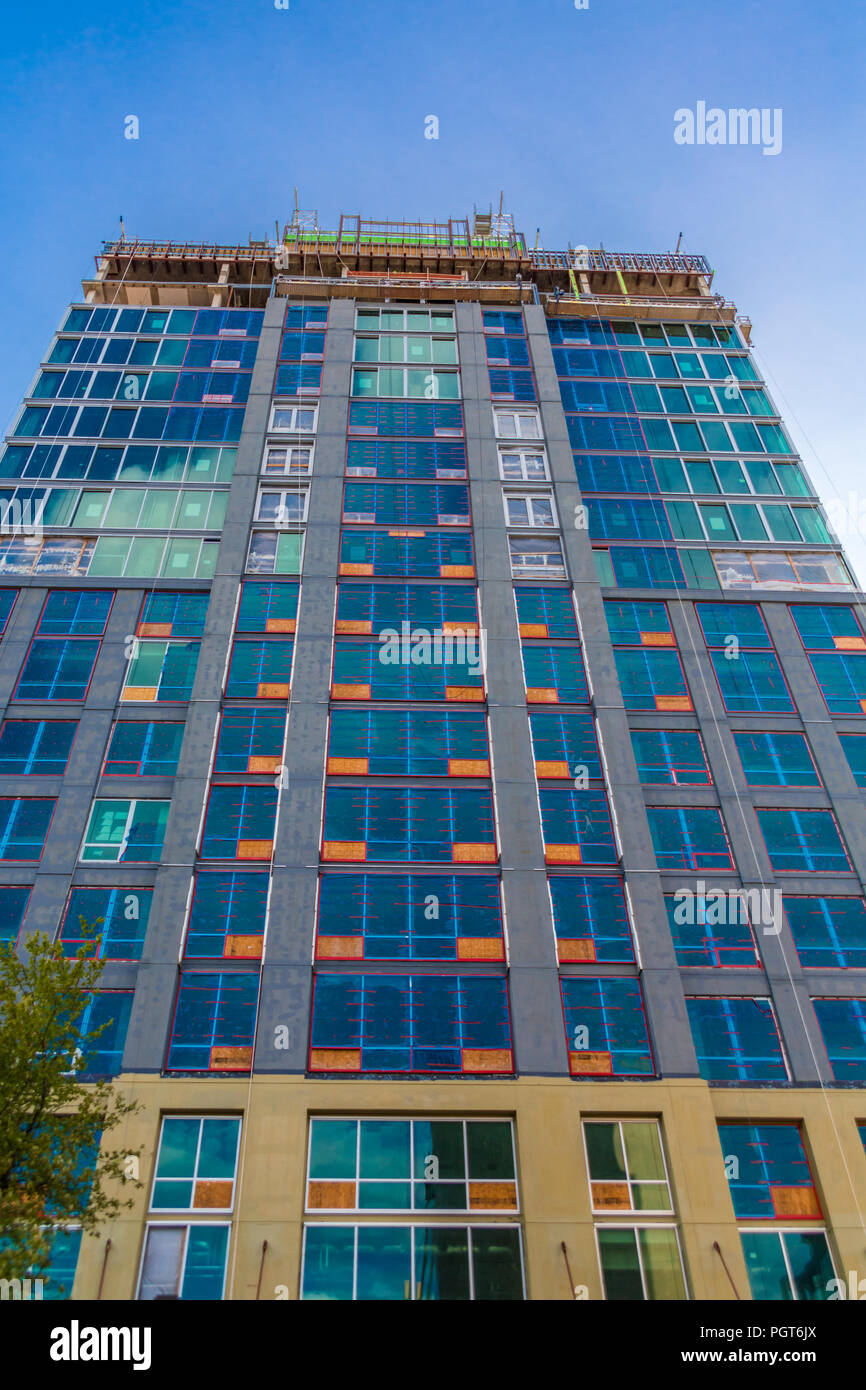 New Glass Tower Construction under Blue Skies Stock Photo - Alamy