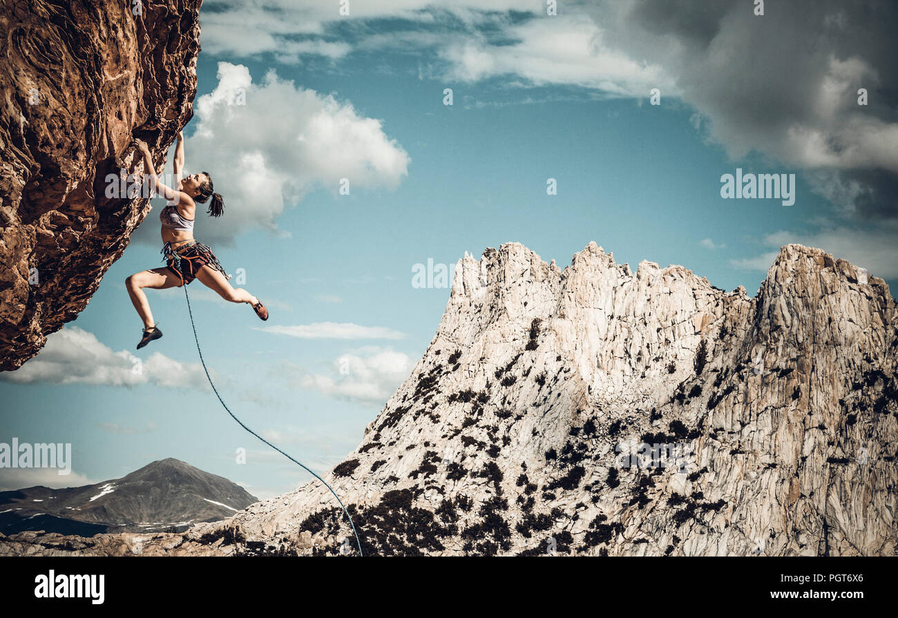 Female climber struggeling up a sheer cliff Stock Photo - Alamy