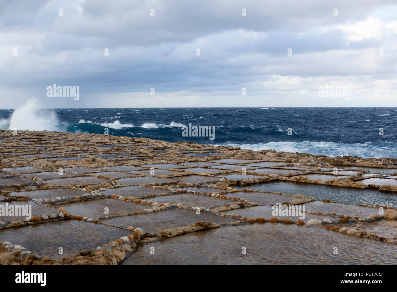 Salt pans and rough sea on Gozo, Malta Stock Photo - Alamy