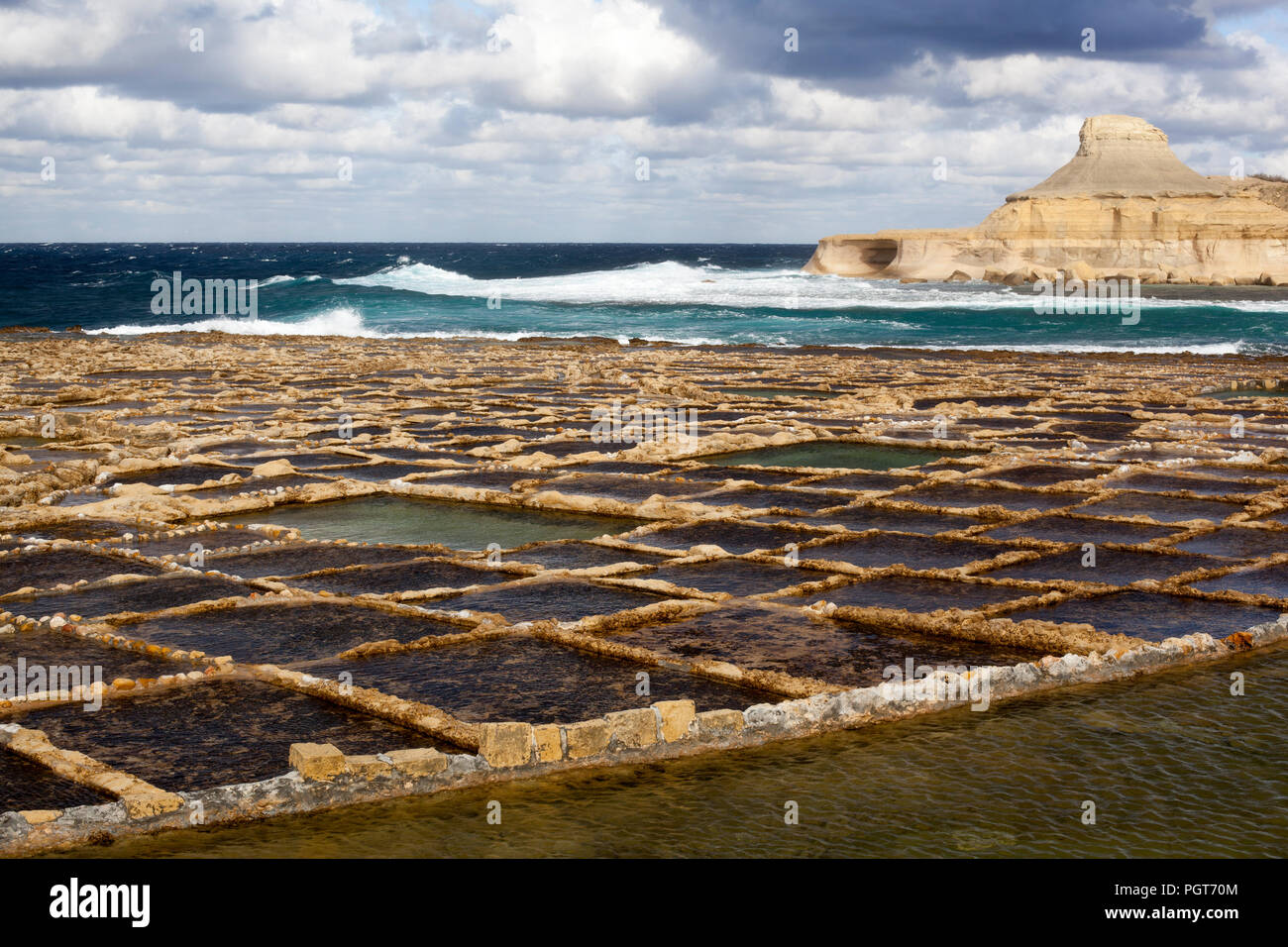 Salt pans and rough sea on Gozo, Malta Stock Photo - Alamy