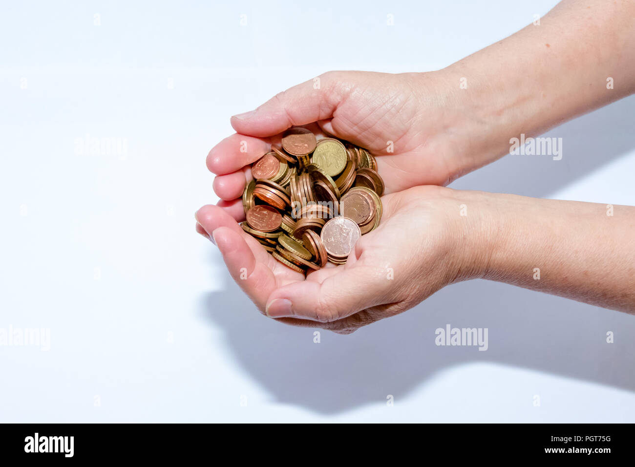 Hands holding coins isolated white background Stock Photo - Alamy