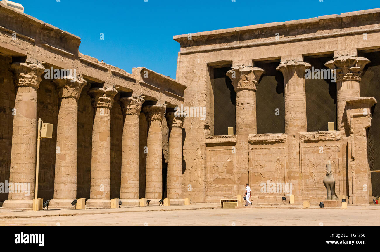 Egyptian guard in white uniform walking in court of offerings courtyard ...