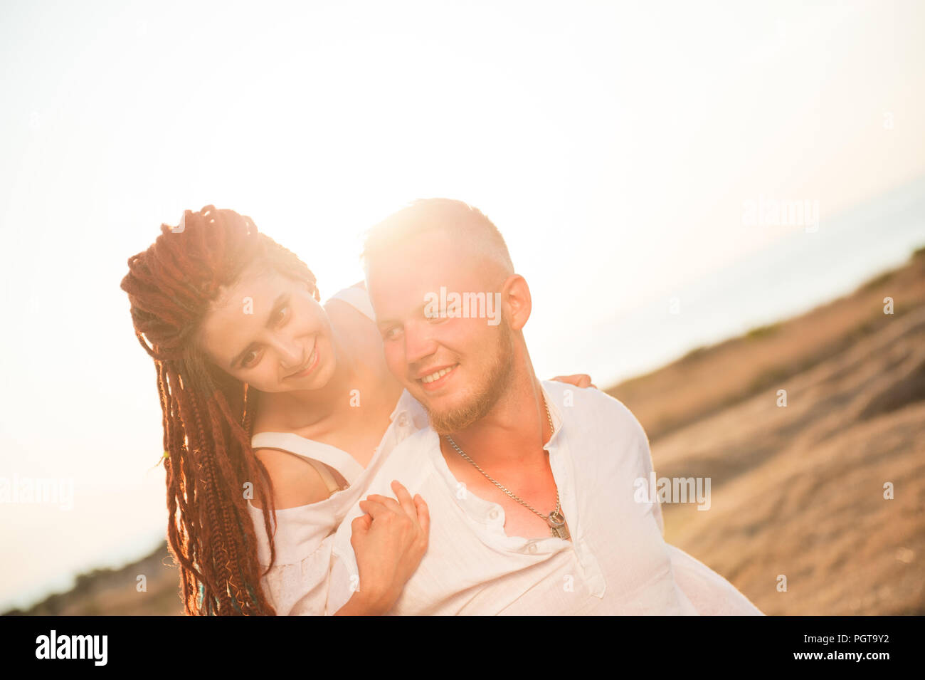 happy young smiling loving nordic man and arabic woman with dreadlocks ...