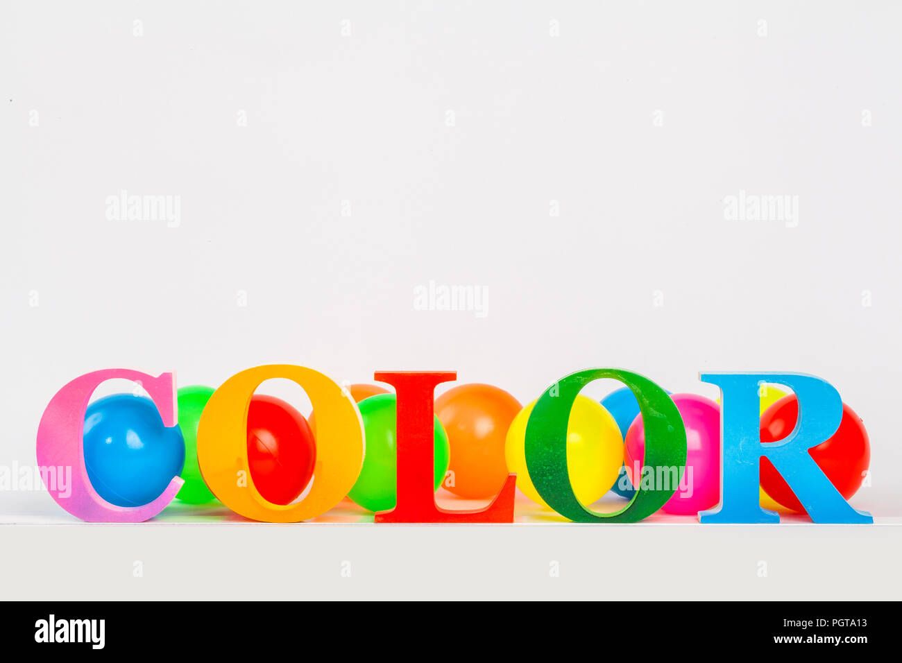 Colorful letters of the word color and colorful ball on the white ...