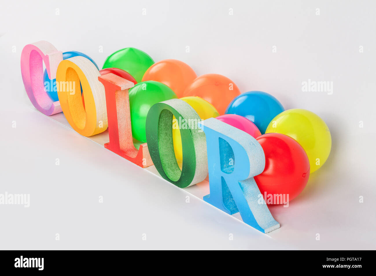 Colorful letters of the word color and colorful ball on the white ...