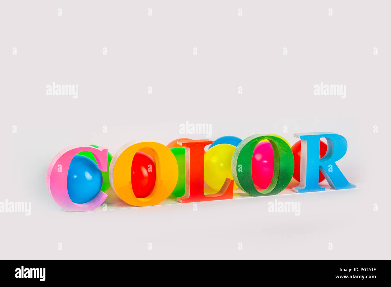 Colorful letters of the word color and colorful ball on the white ...