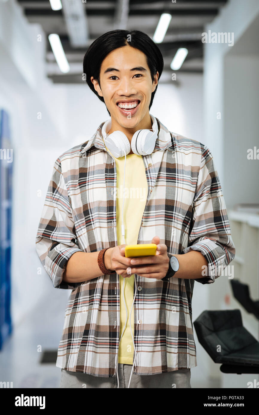 Positive man smiling while typing messages to friends Stock Photo - Alamy Positive man smiling while typing messages to friends Stock Photo - Alamy