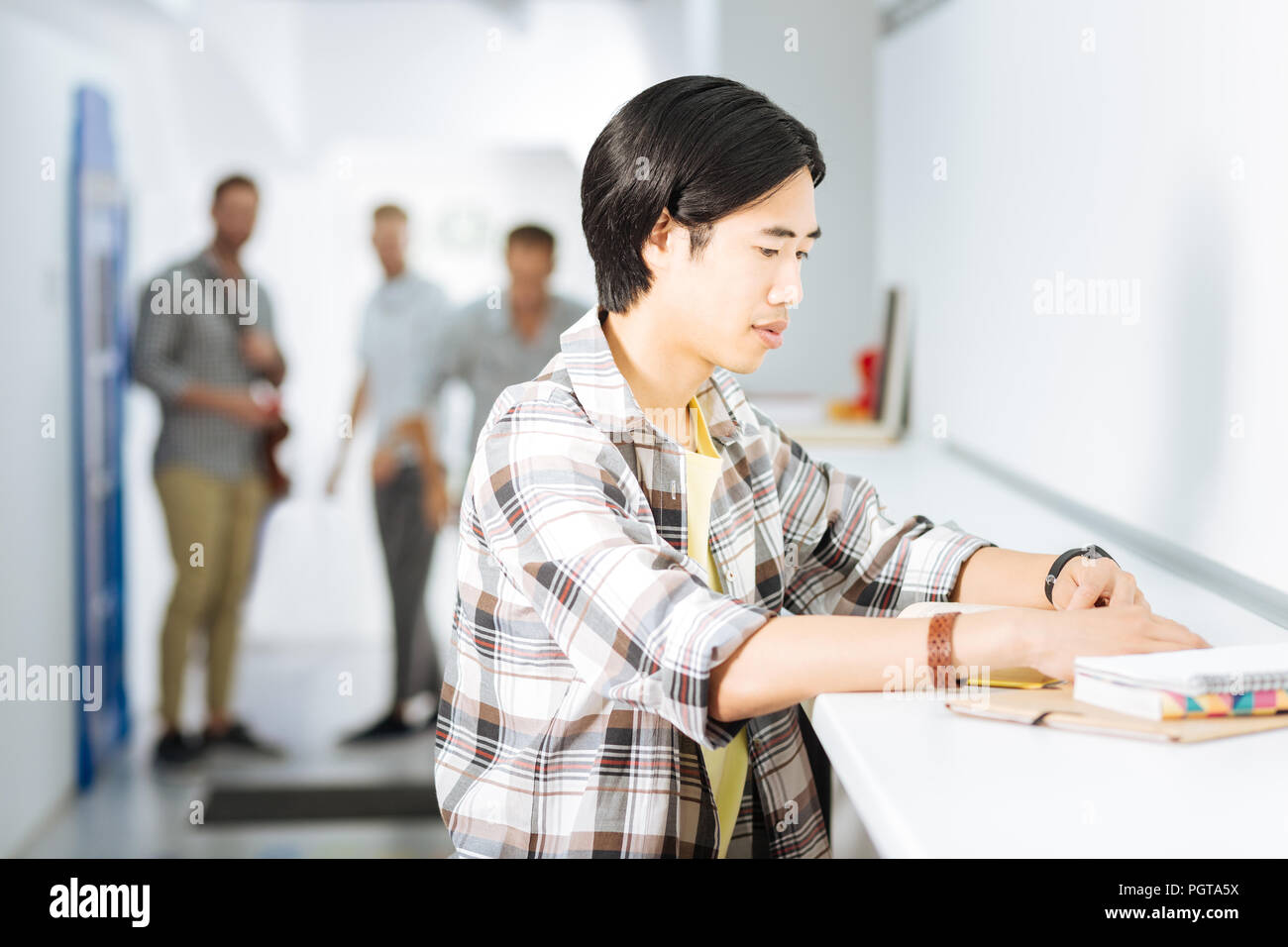 Concentrated student doing homework while being in coworking space ...
